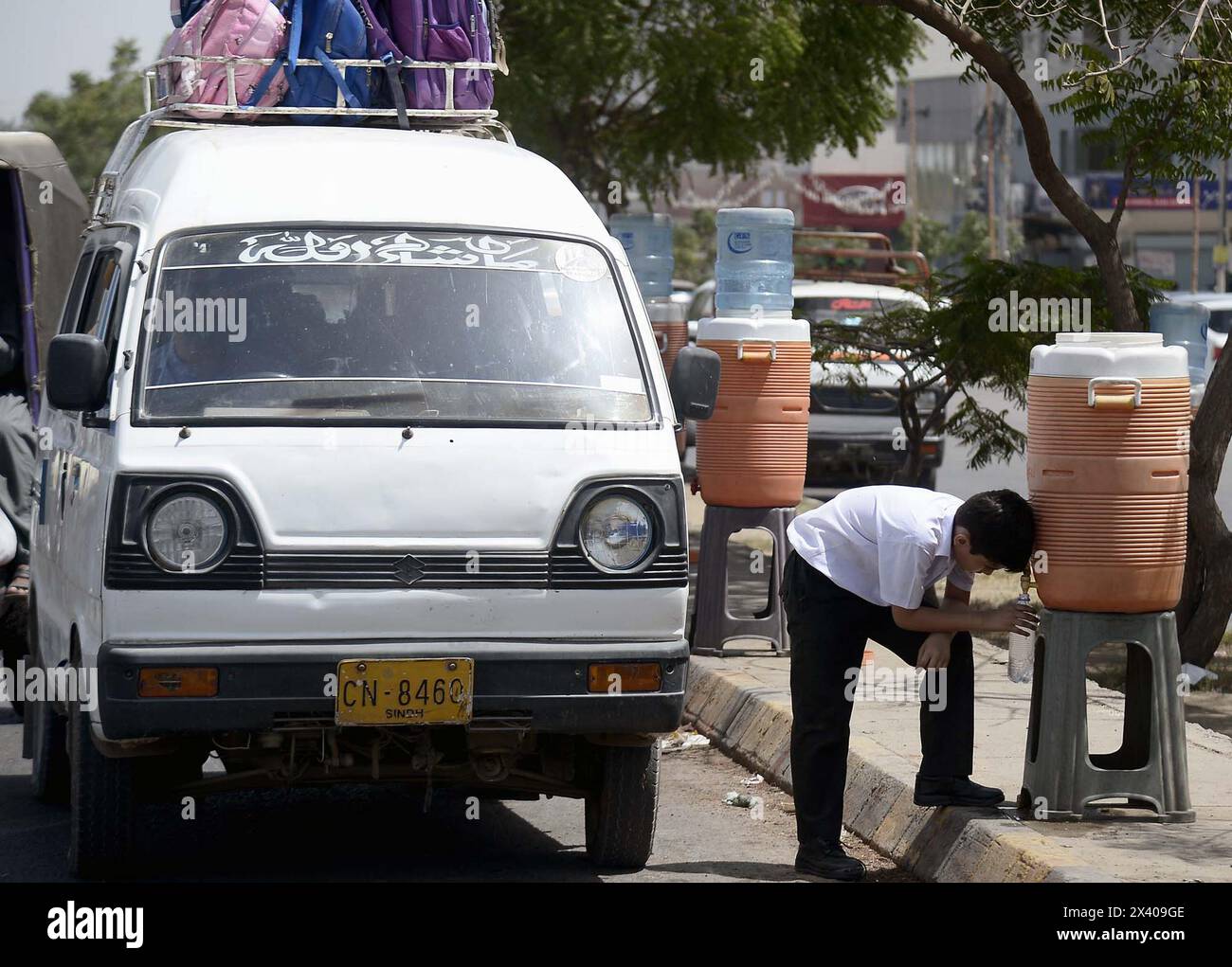 Commuters are drinking chilled water to beat the heat of sun at a camp ...