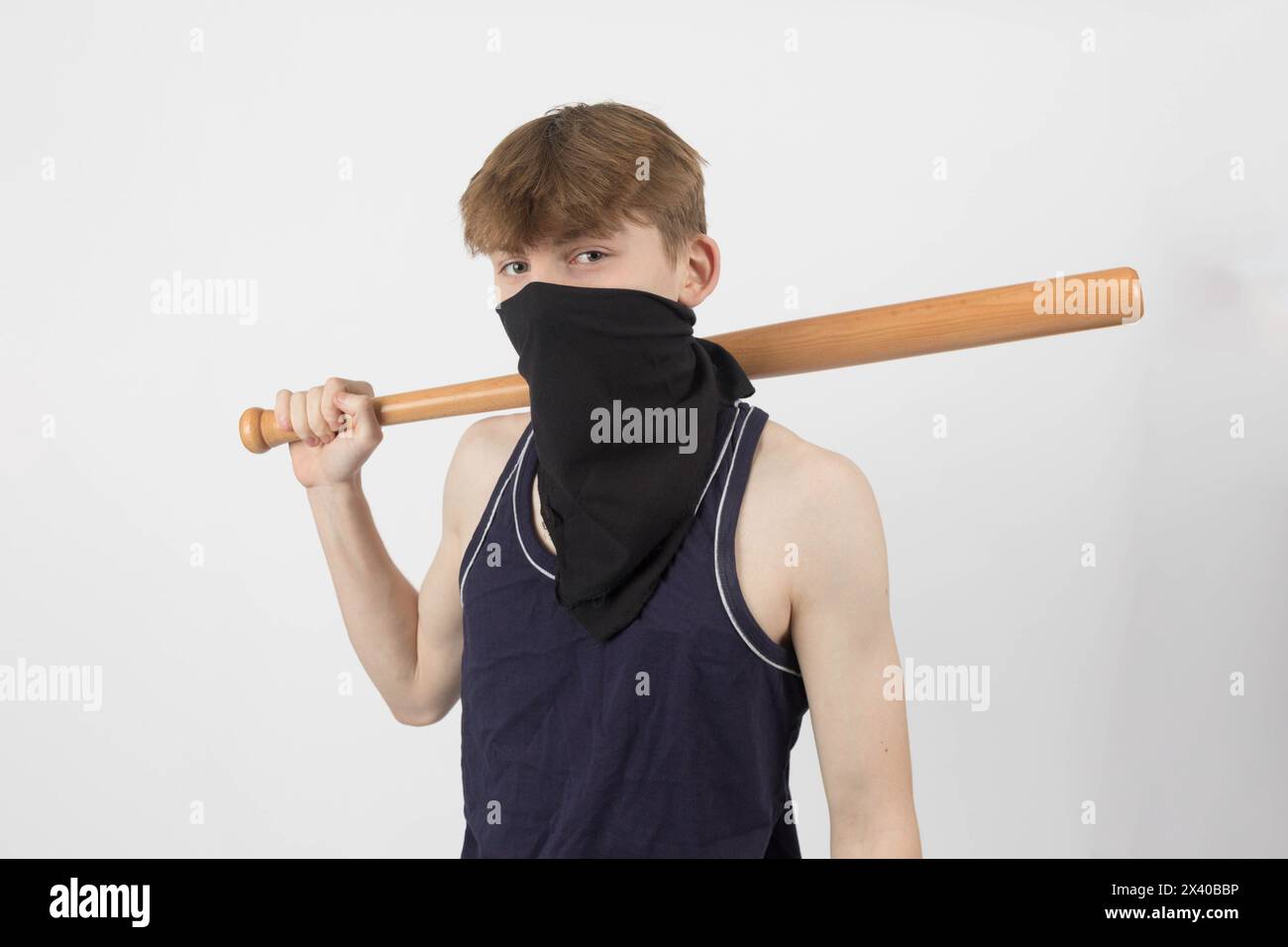A Teenage Male Gang Member in a mask holding a baseball bat over his ...