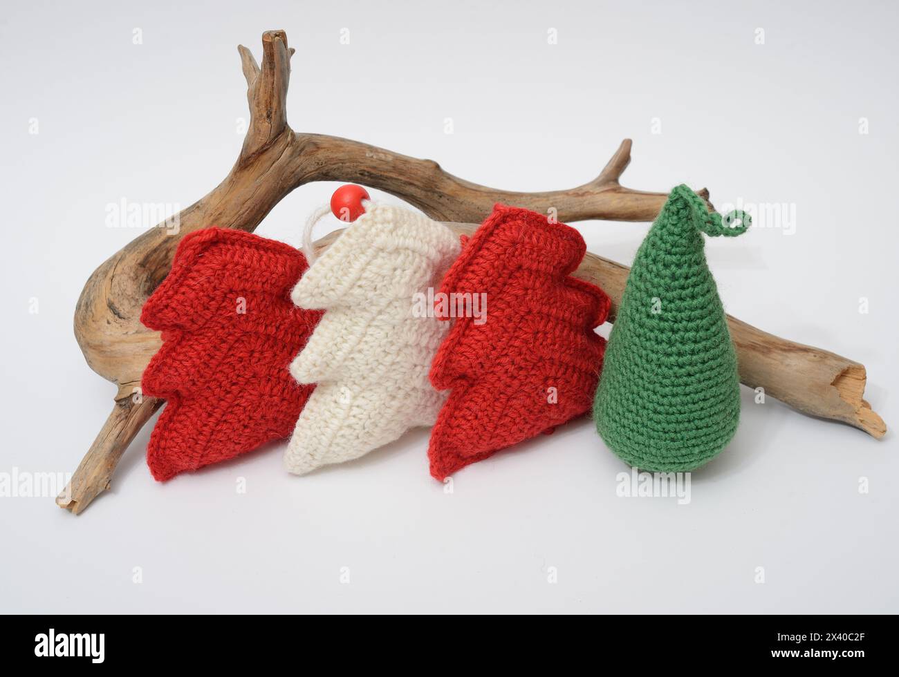Crafted with care, the knitted trees stand tall, a wooden base adding ...