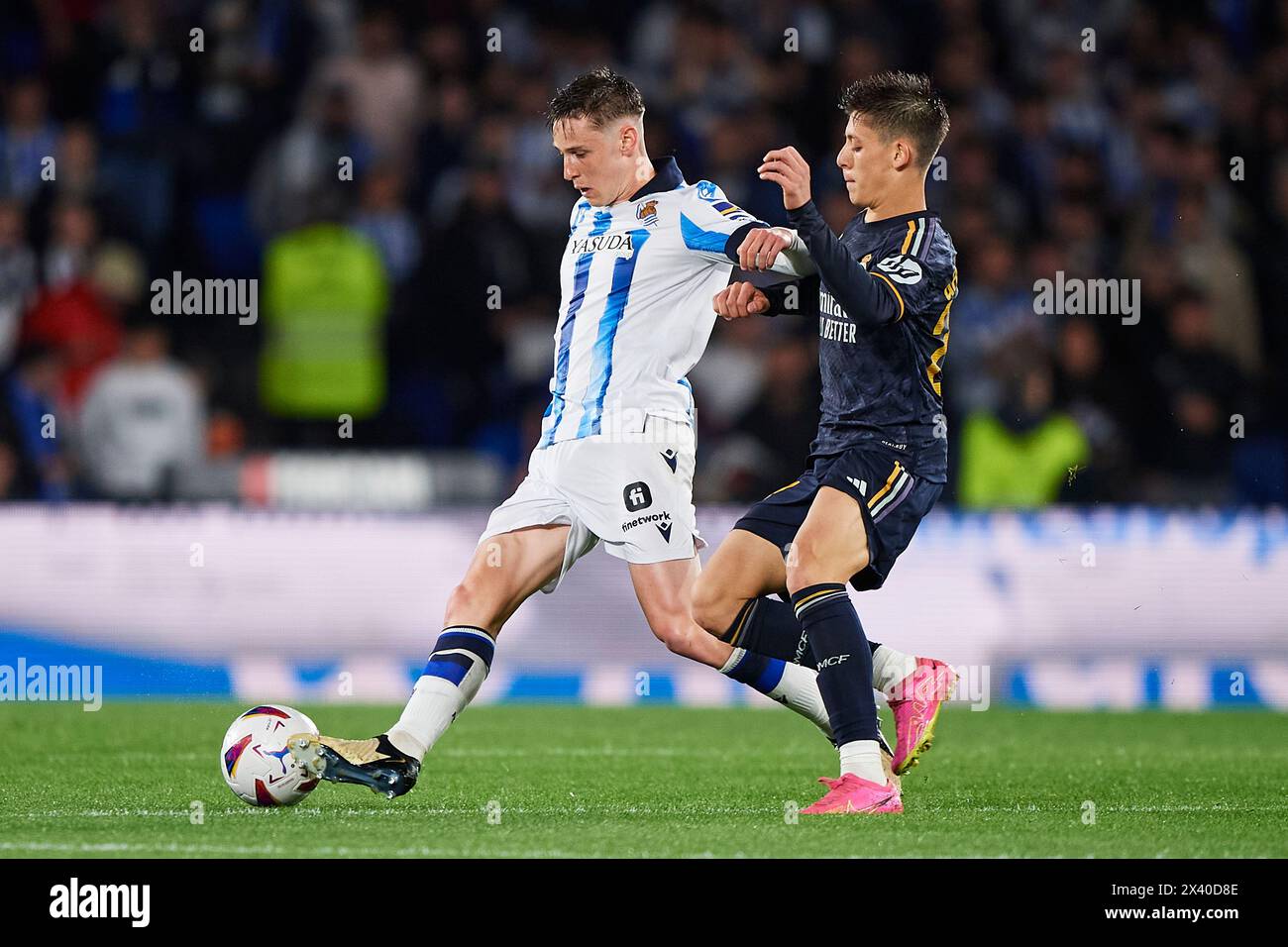 Benat Turrientes of Real Sociedad compete for the ball with Arda Guler ...