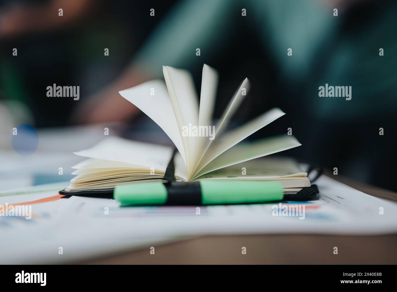 Open book on a busy office desk captures the essence of a dynamic ...