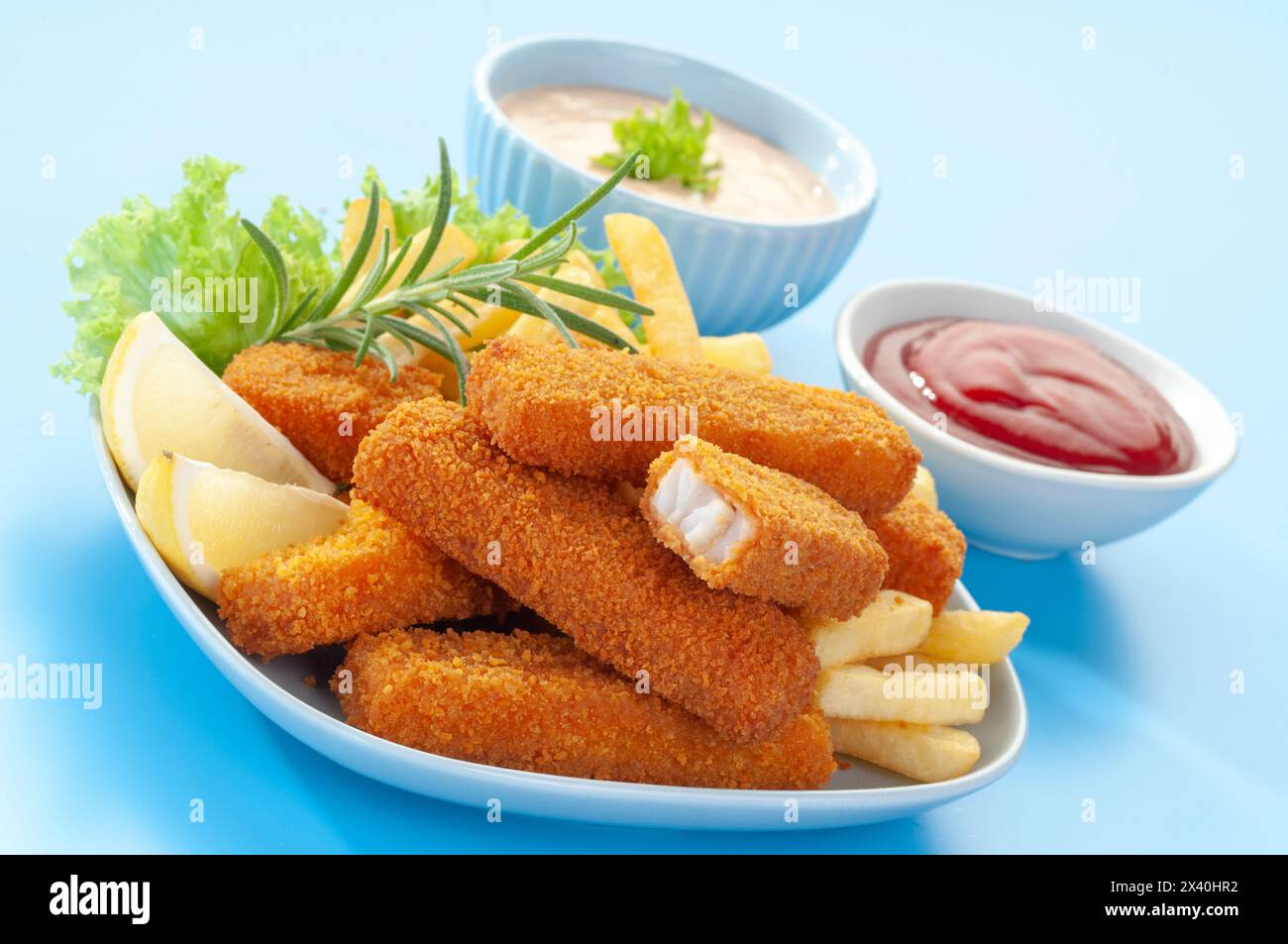 Fried Breaded fish Fingers with salad and condiments Stock Photo - Alamy