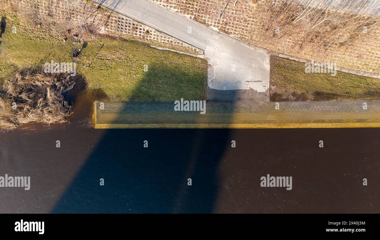 Drone photography of flooded riverside bank in a city during spring ...
