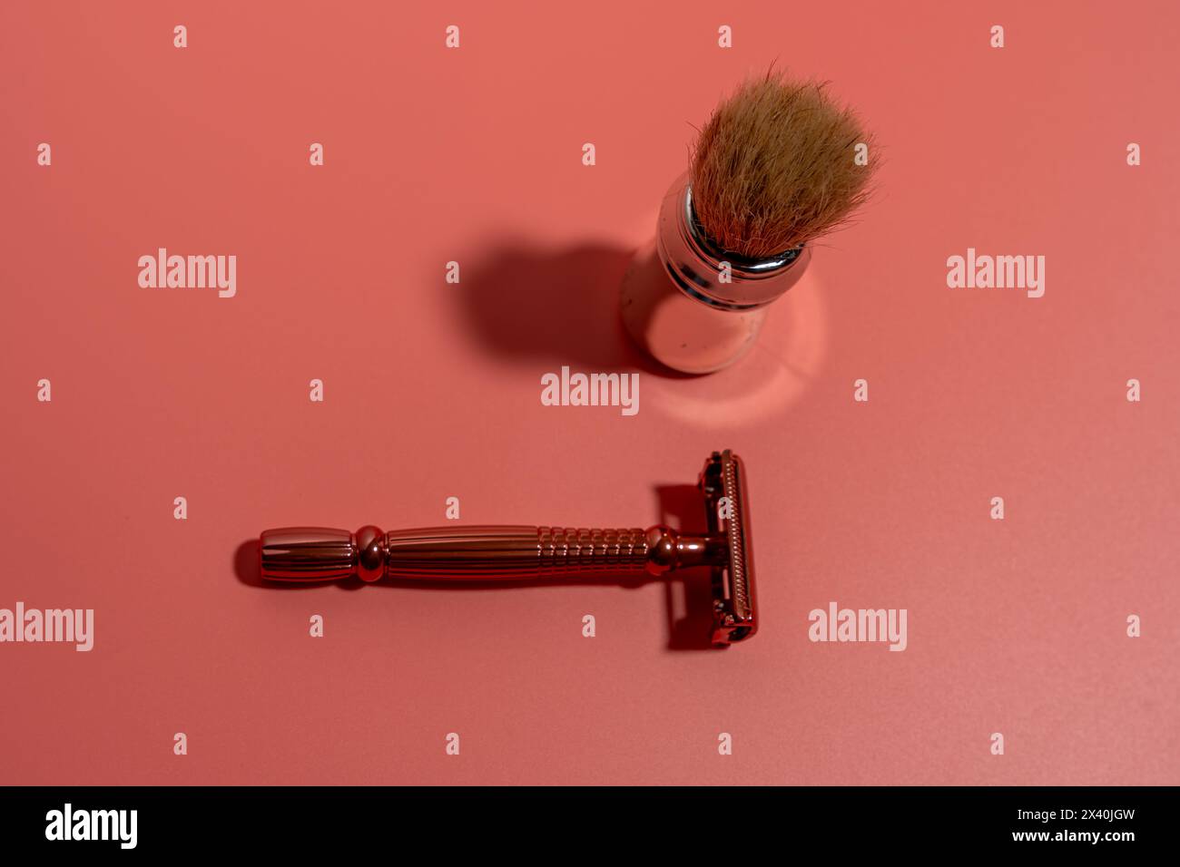 Metal razor and pen brush on a pink background. Razor close-up Stock ...