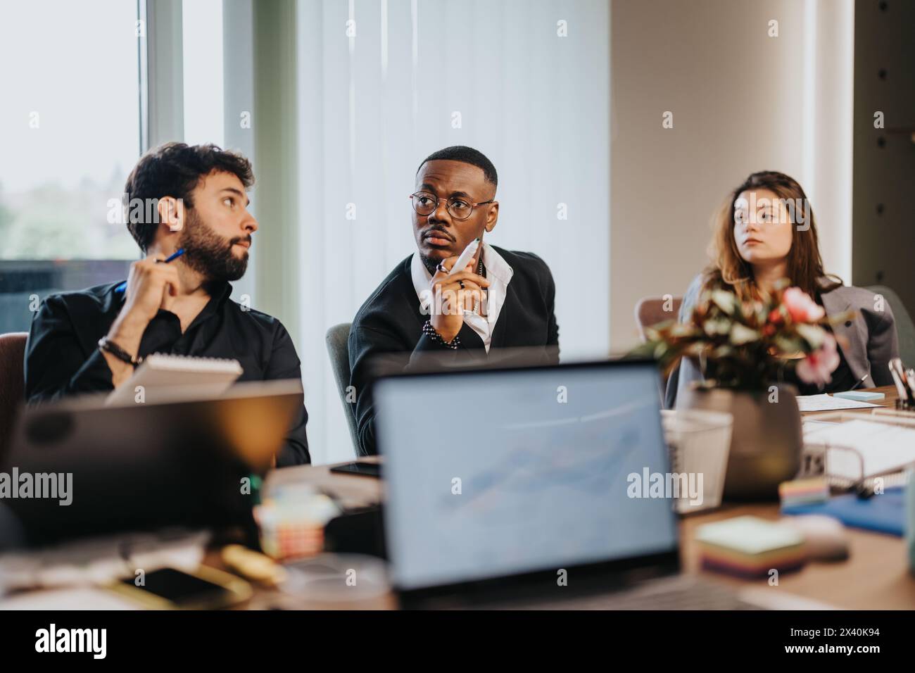 Business meeting in progress with diverse team analyzing growth ...