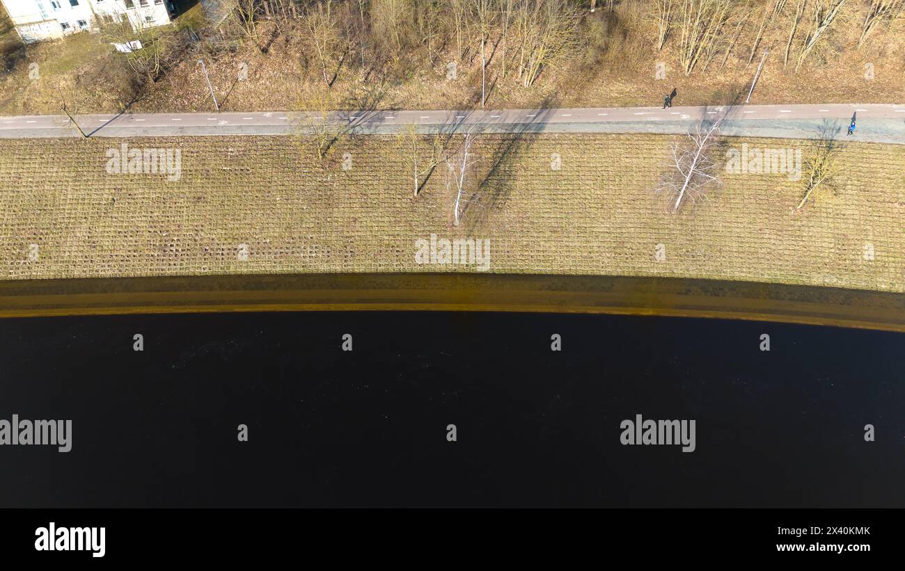 Drone photography of flooded riverside bank in a city during spring ...
