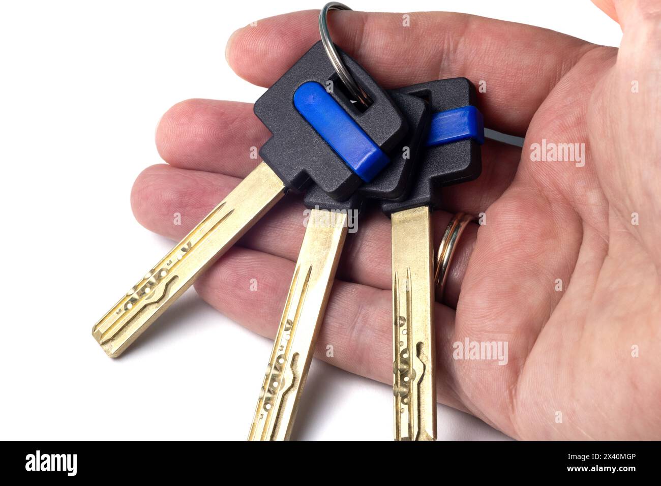 Bunch of modern door keys on the hand palm isolated on a white ...