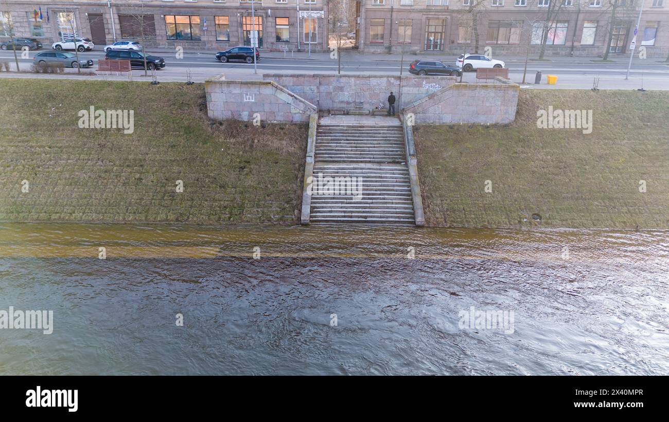 Drone footage of flooded riverside bank in a city and stairs going to ...