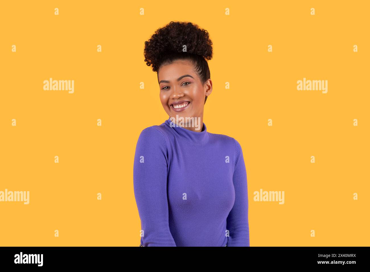 Smiling Woman in Purple Shirt and Jeans Stock Photo - Alamy