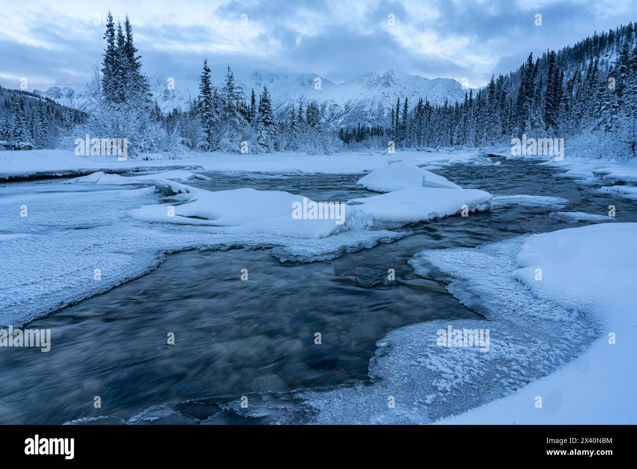 Snow-covered mountains known as the Grey Ridge highlight the background ...