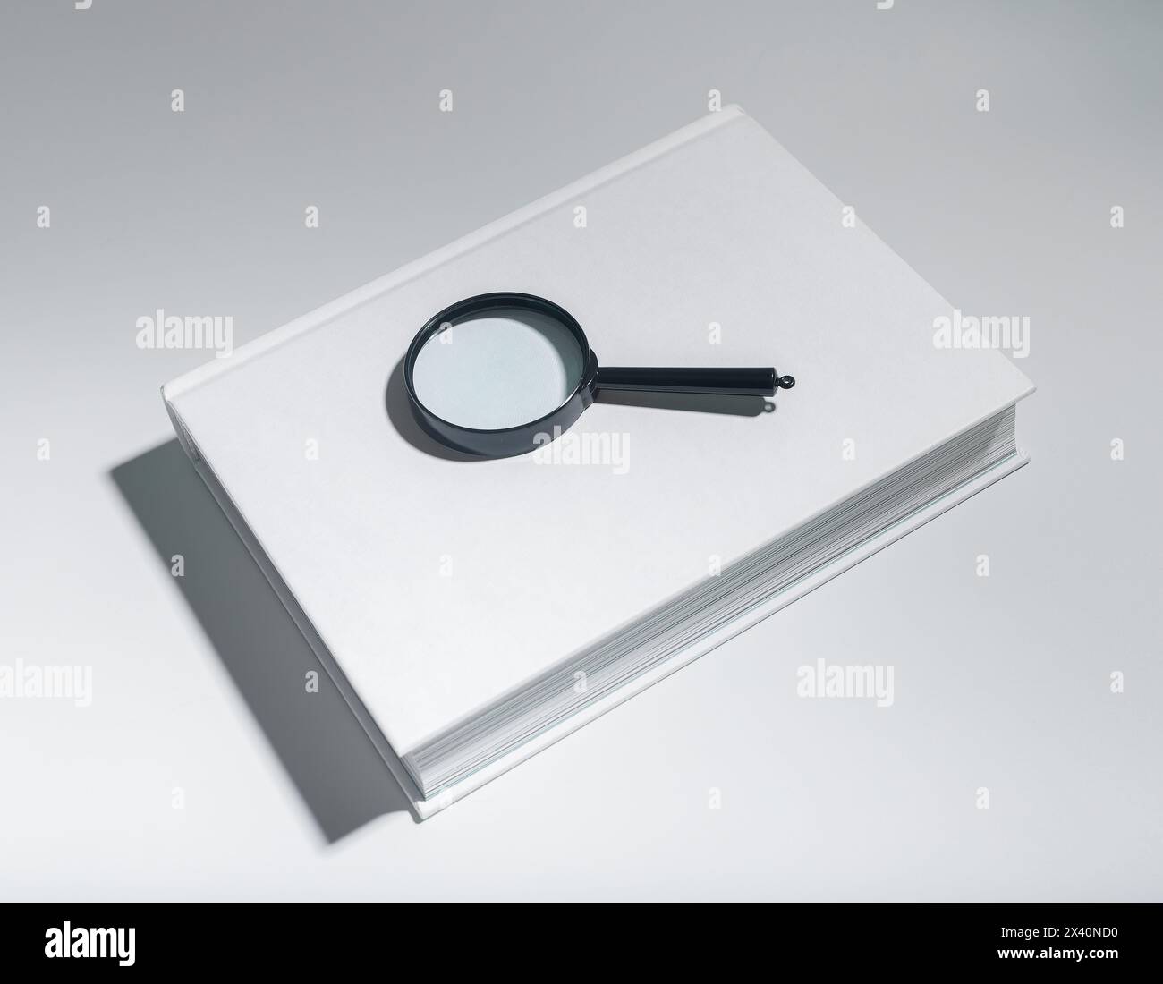 Financial research with magnifying glass, inspecting documents, books. Educational focus in ...