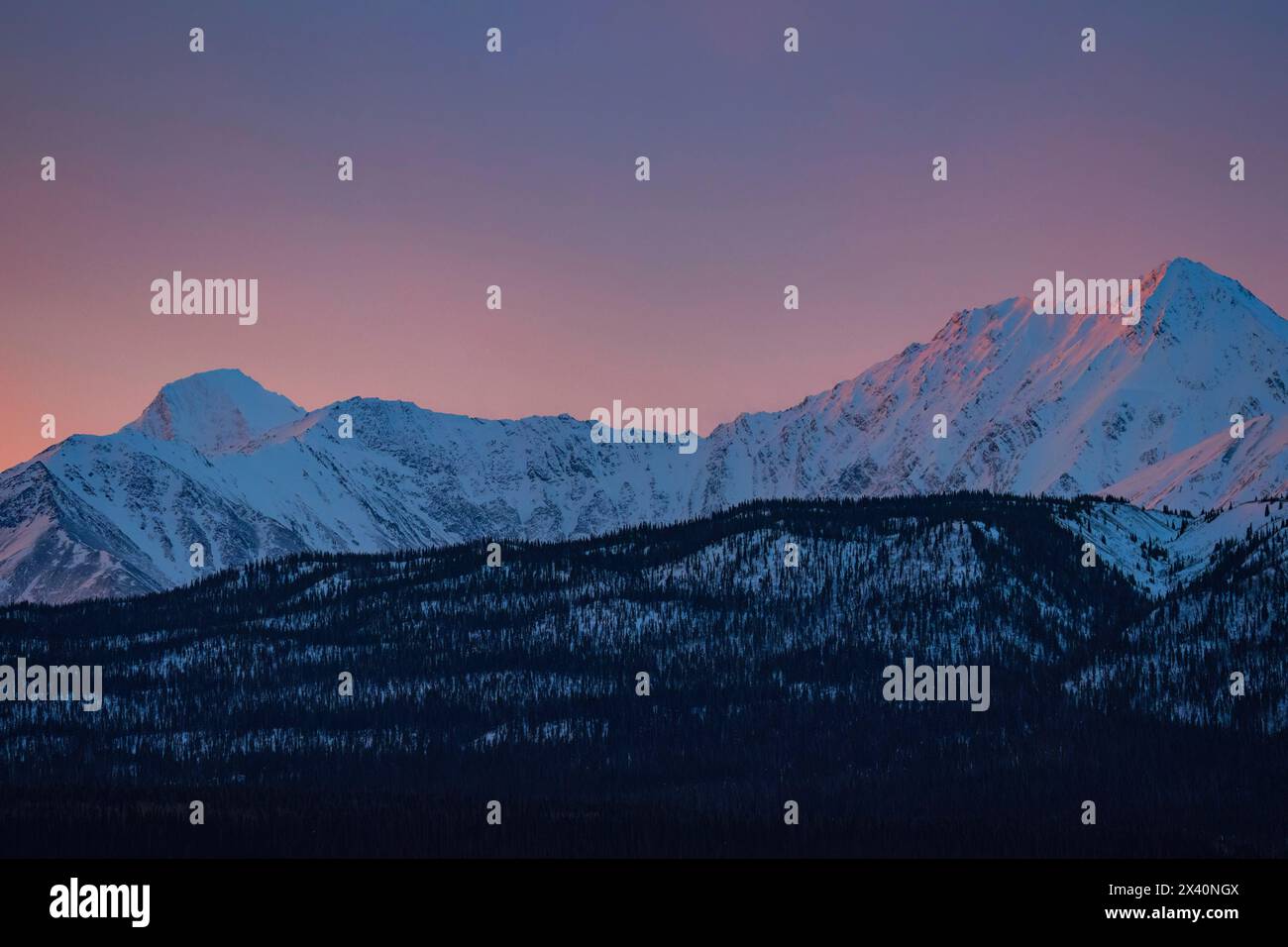 Rising sun illuminates the front ranges of the St. Elias mountain ...