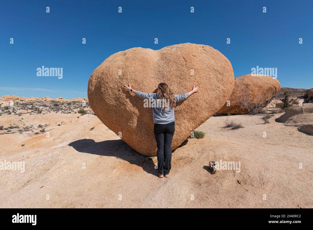Woman exploring the beautiful rocks in Joshua Tree National Park ...