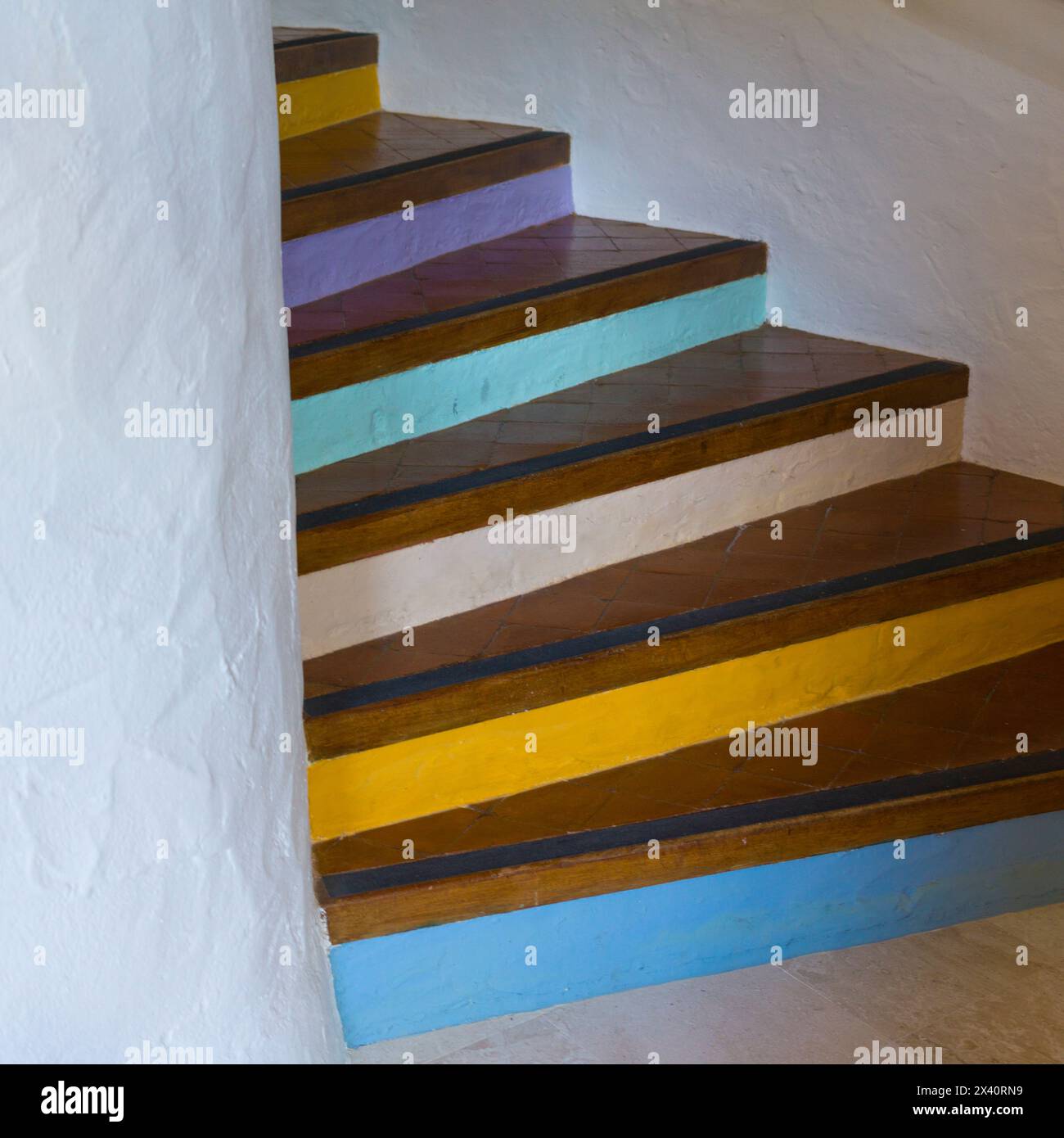 Close-up of steps with risers painted in various colours and whitewash ...