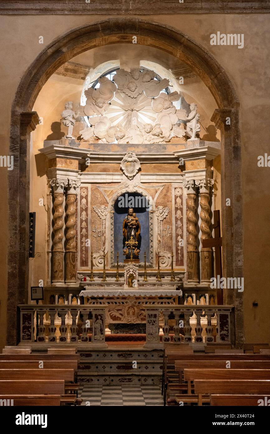 Church altar with ornate facade and sculpture in Alghero, Italy ...