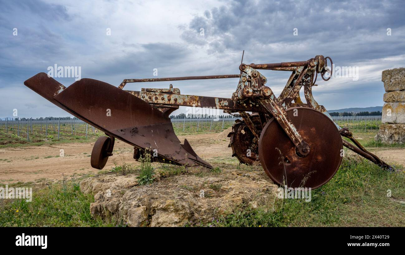 Rusted and vintage farming equipment on a farm; Alghero, Sassari, Italy ...