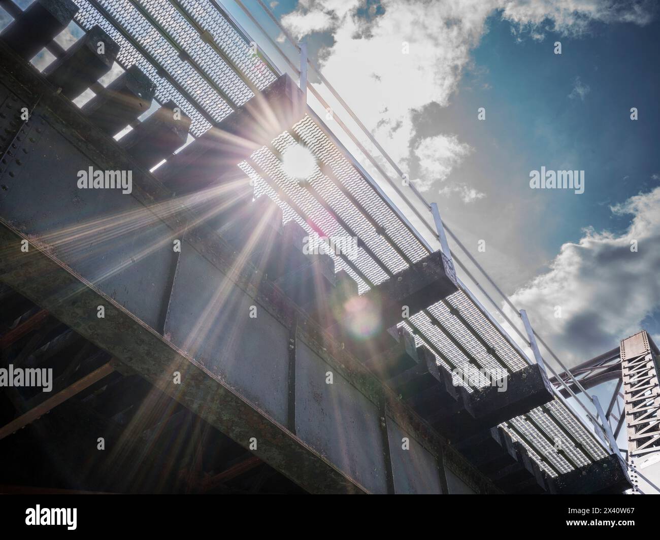 Bright sunlight shining through a bridge structure with sun rays and ...