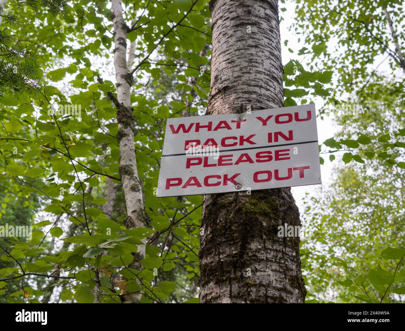 Reminder sign at a campground to clean up, 'what you pack in, please ...