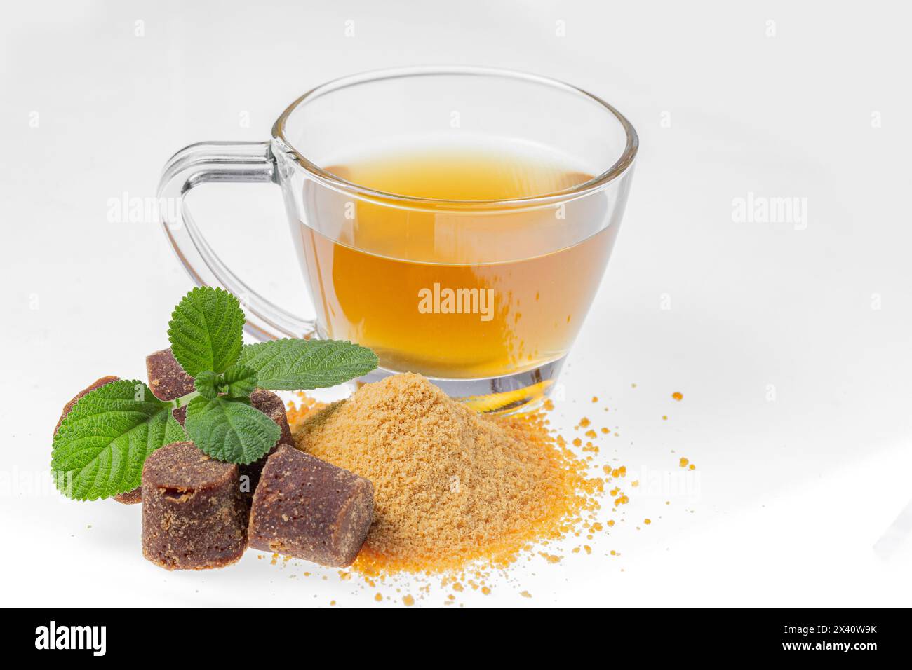 Drink of piloncillo and ground piloncillo, on white background ...