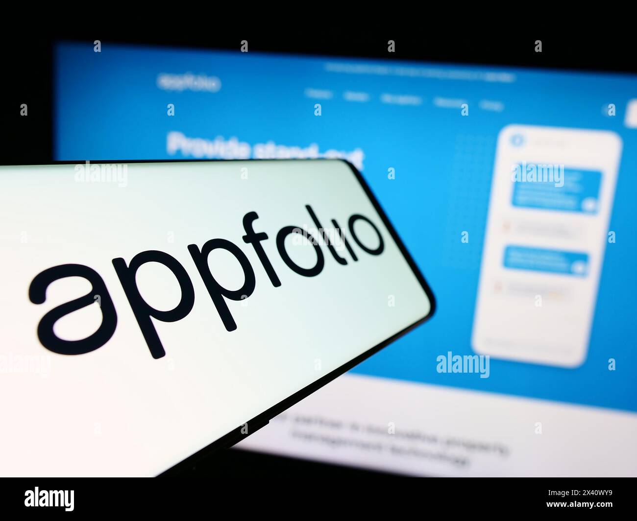 Mobile phone with logo of American real estate software company AppFolio Inc. in front of ...