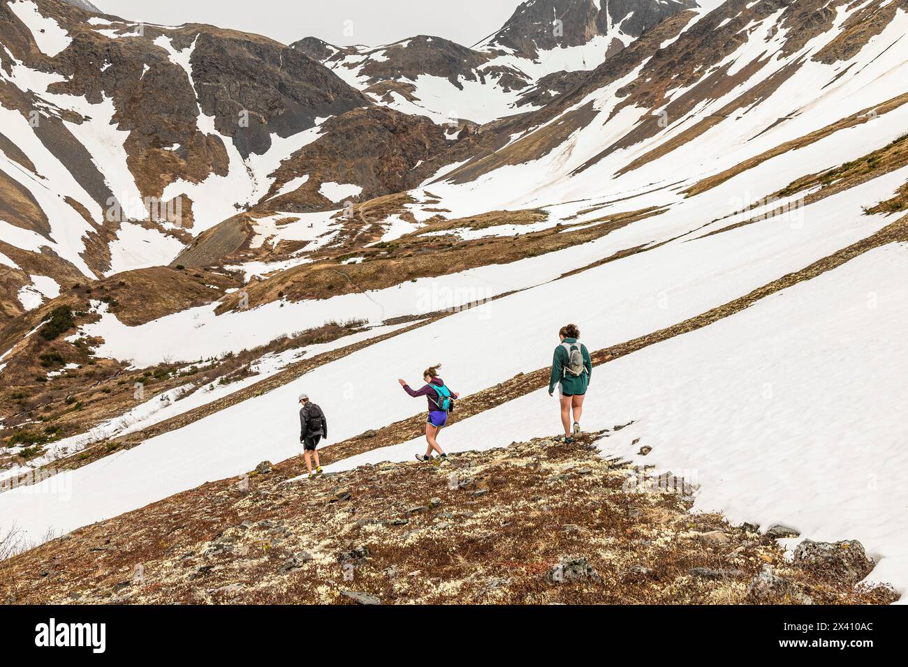 Three teenagers hiking Crow Pass Trail near Girdwood, Alaska, wearing ...