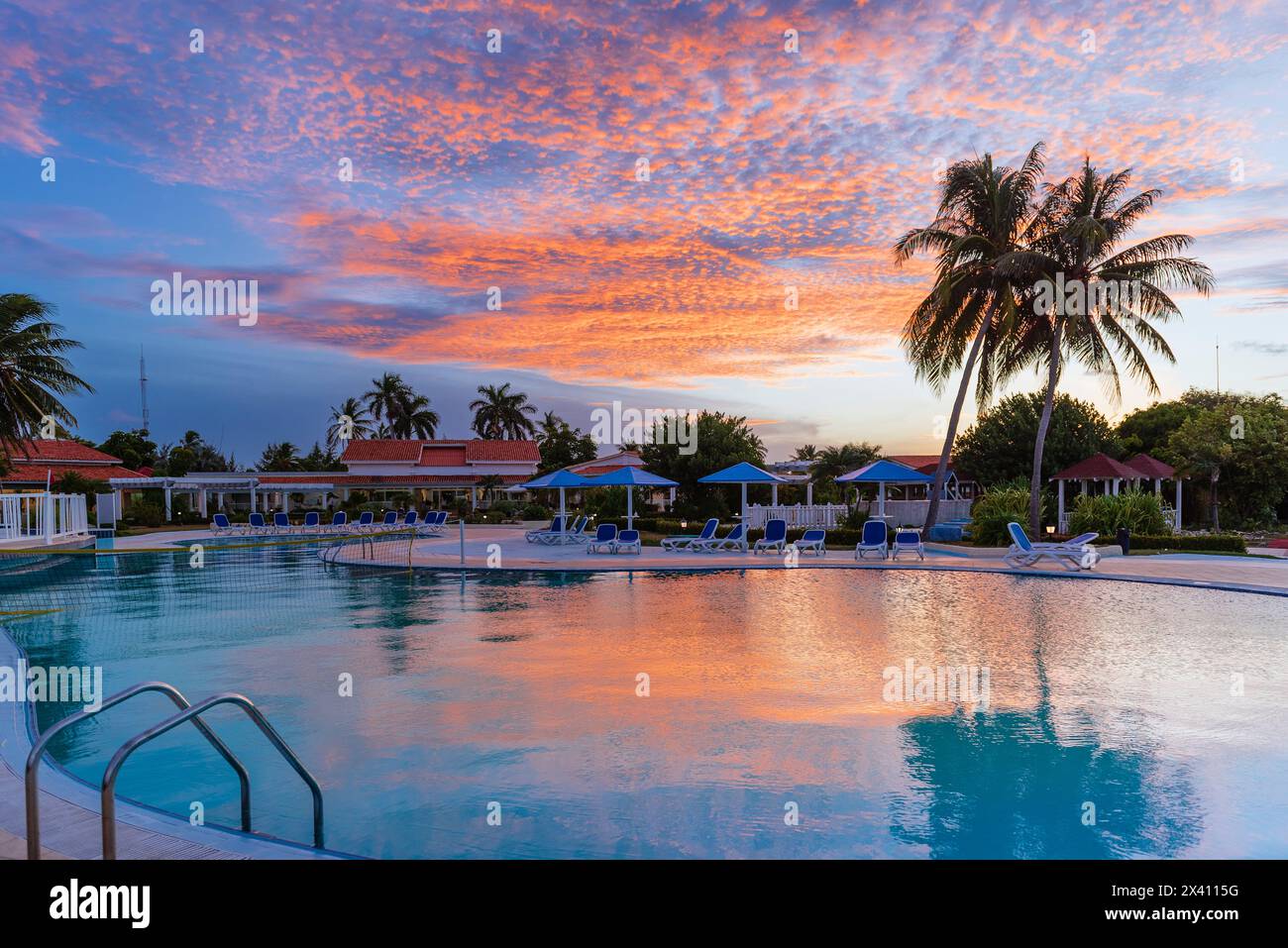 Sunset light reflected in a swimming pool at a resort in the Caribbean ...