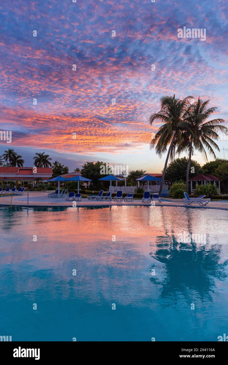 Sunset light reflected in a swimming pool at a resort in the Caribbean ...