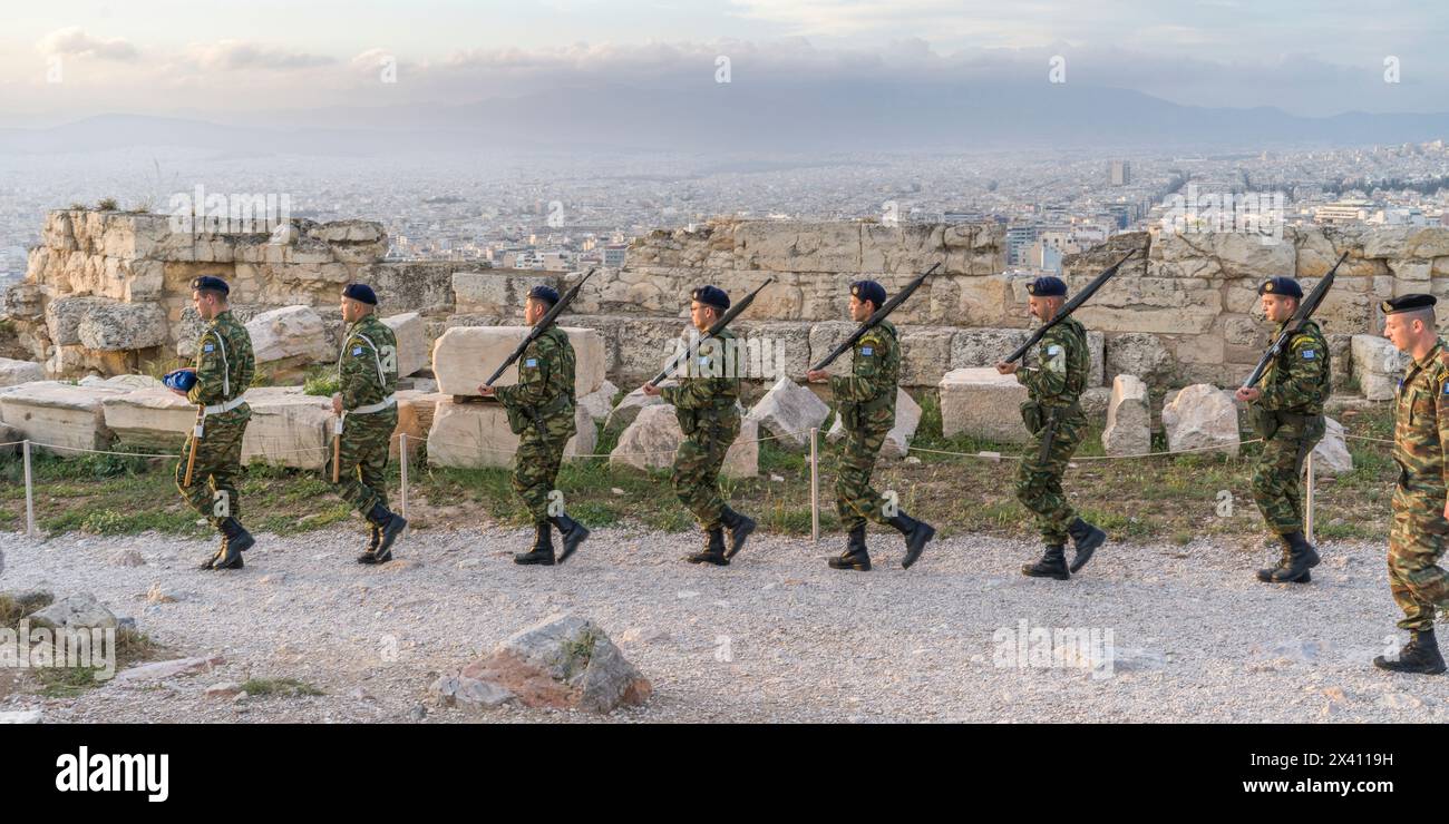 Military personnel walking in a row at the Acropolis of Athens is an ...