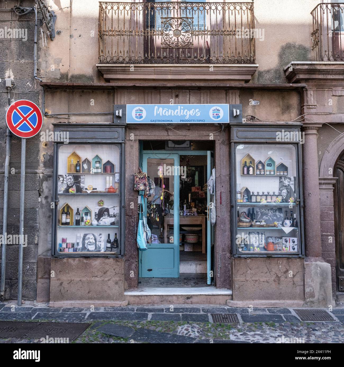 Storefront with wares on display in front windows in Bosa, Italy; Bosa ...