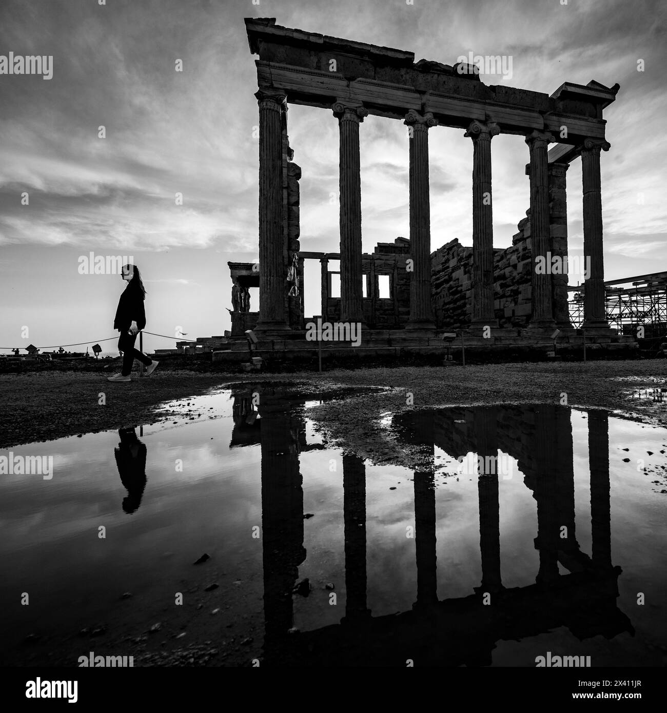 Tourist and a colonnade at the Acropolos of Athens, with the mirror ...