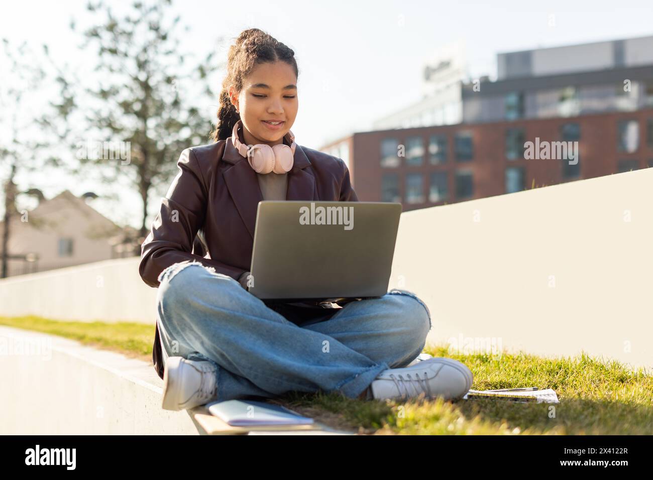 Girl Sitting on Bench Using Laptop Computer Stock Photo - Alamy