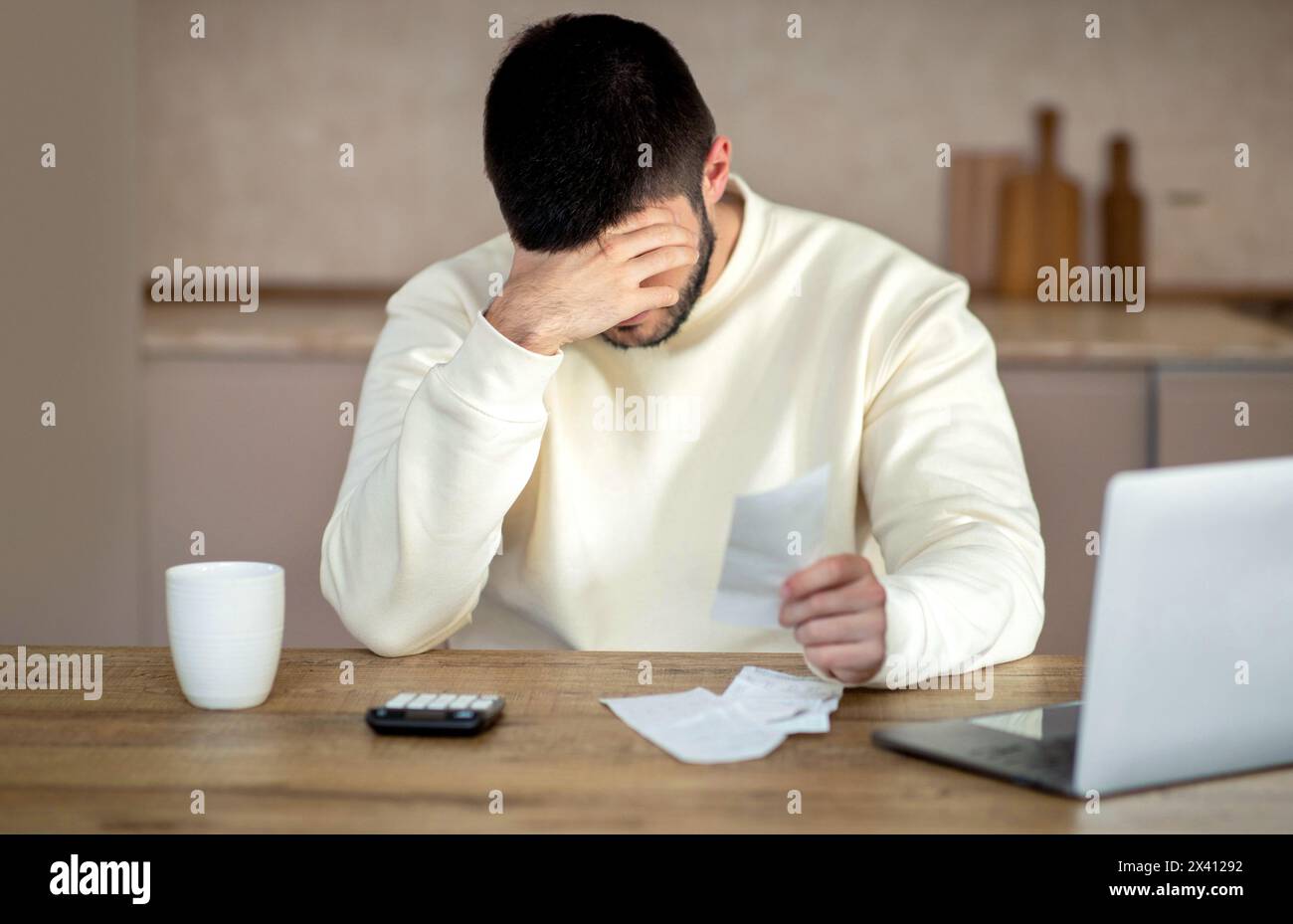 Man sitting gesture despair table hi-res stock photography and images ...