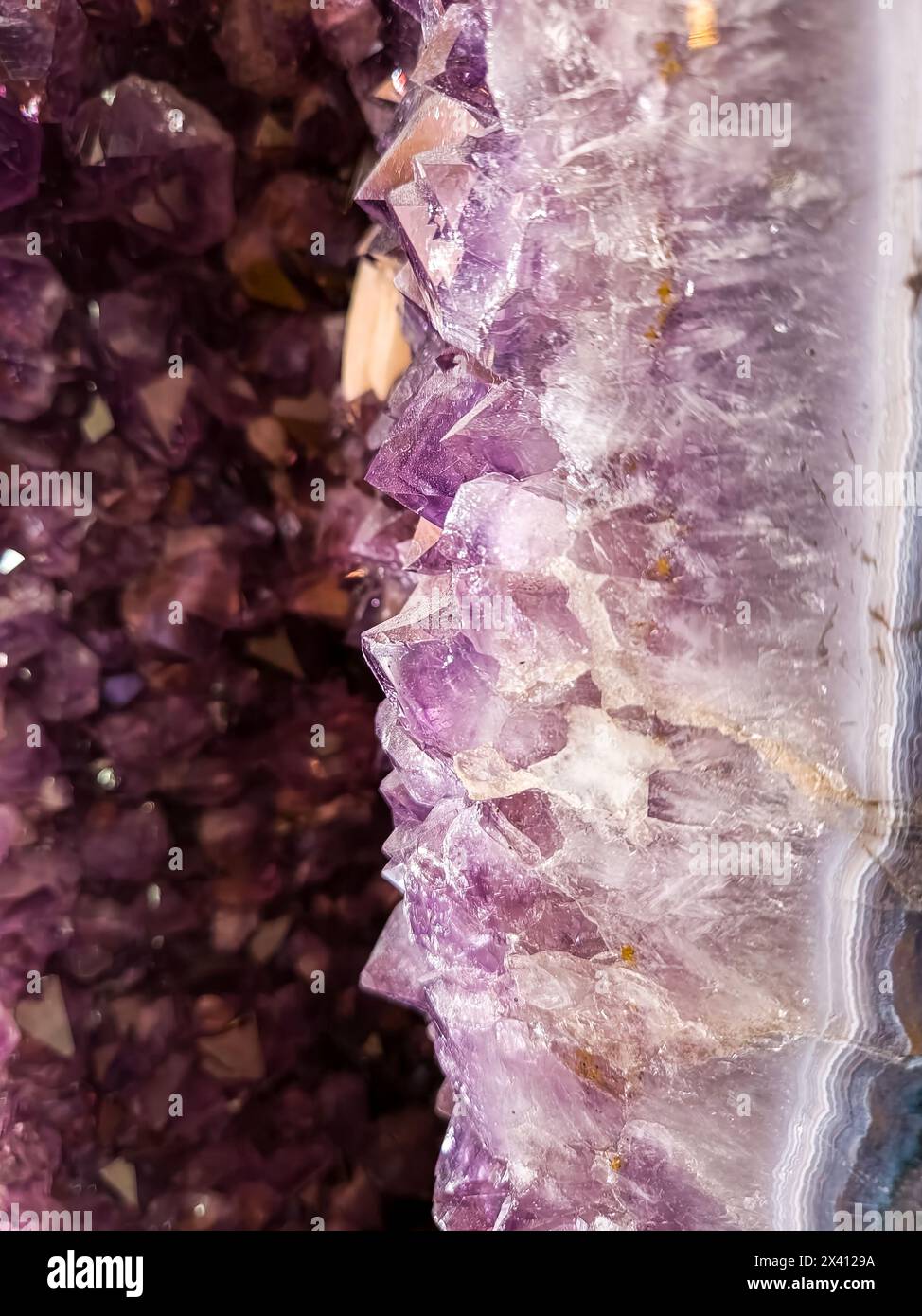 Amethyst geode close up of edge with crystals in background Stock Photo ...