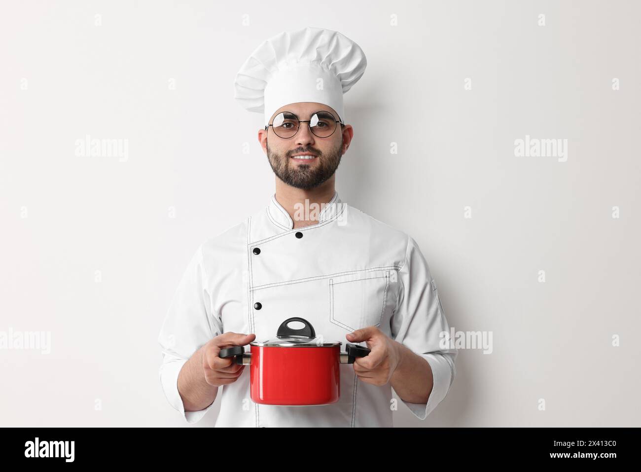Professional chef with cooking pot on white background Stock Photo - Alamy