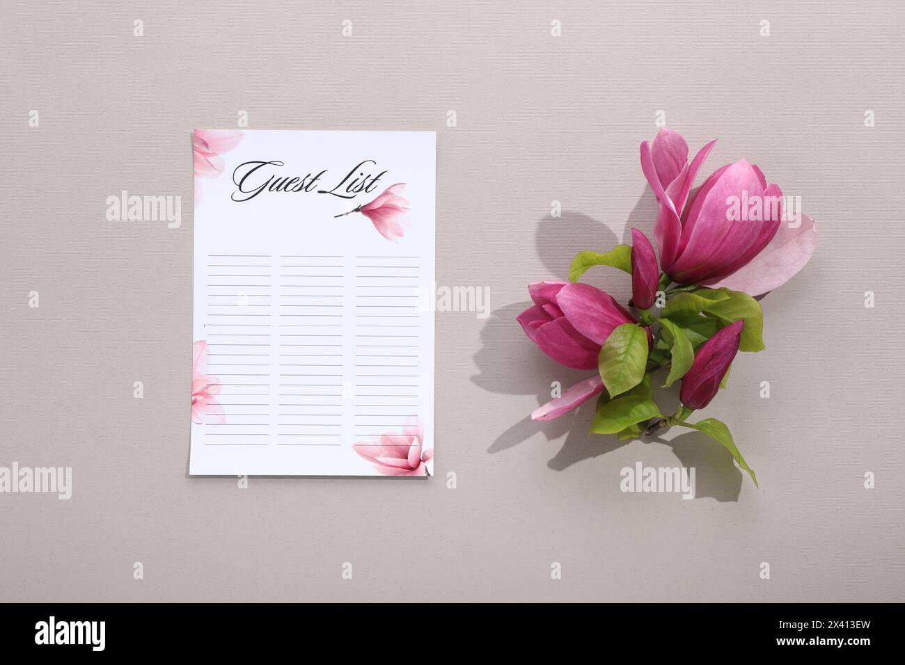 Guest list and beautiful flowers on grey background, flat lay. Space ...
