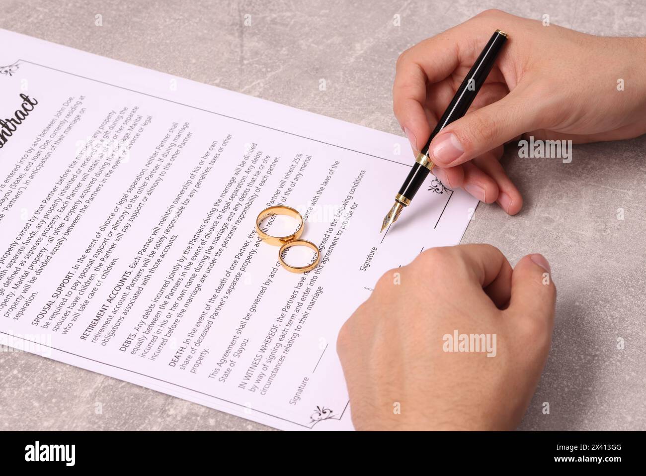Man signing marriage contract at light grey table, closeup Stock Photo ...