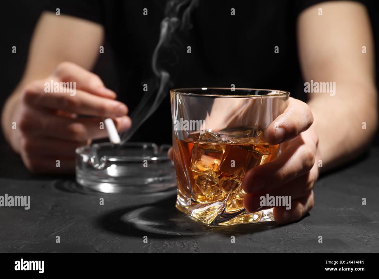 Alcohol addiction. Man with glass of whiskey and smoldering cigarette ...
