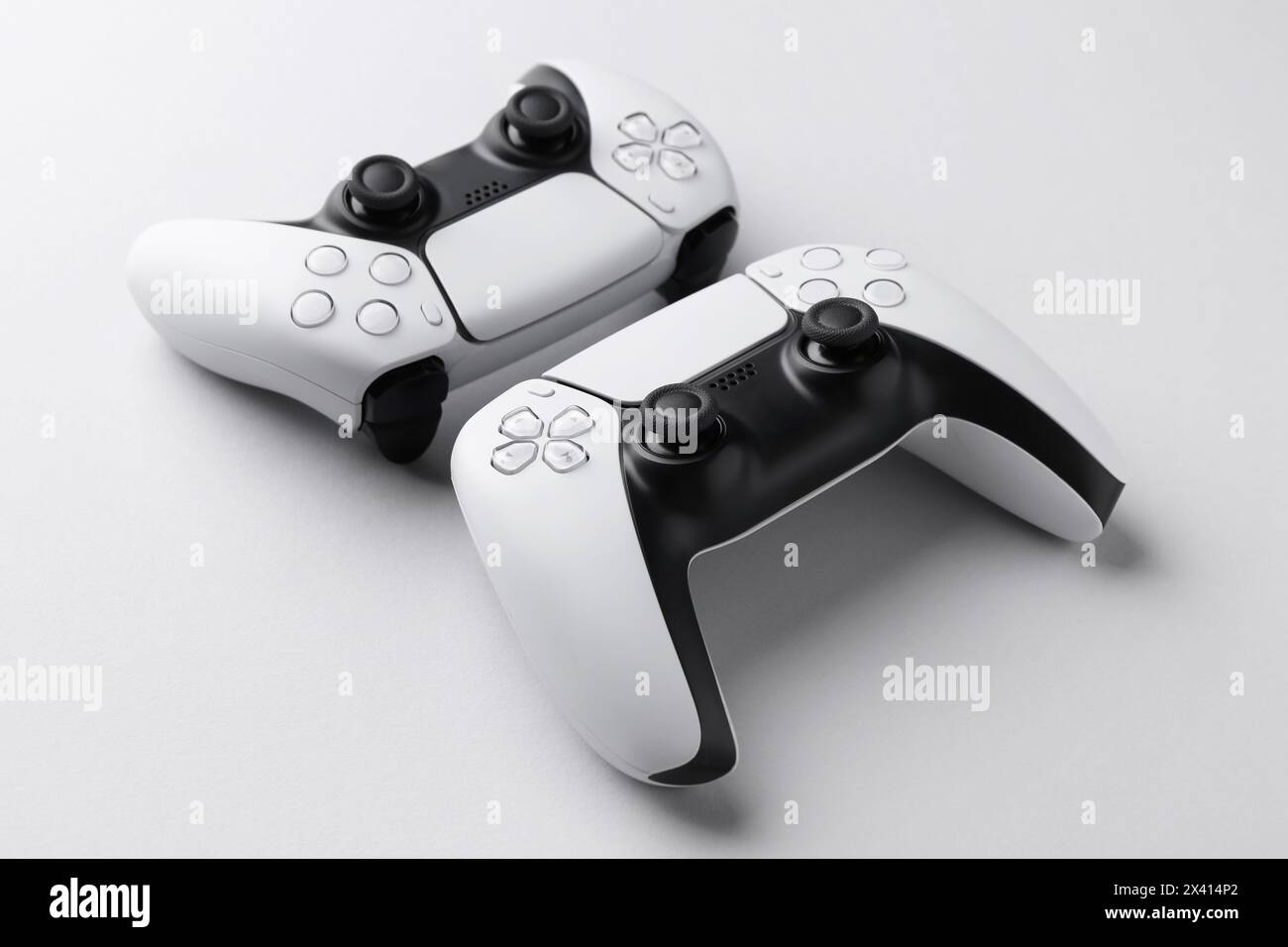 Wireless game controllers on light grey background Stock Photo - Alamy