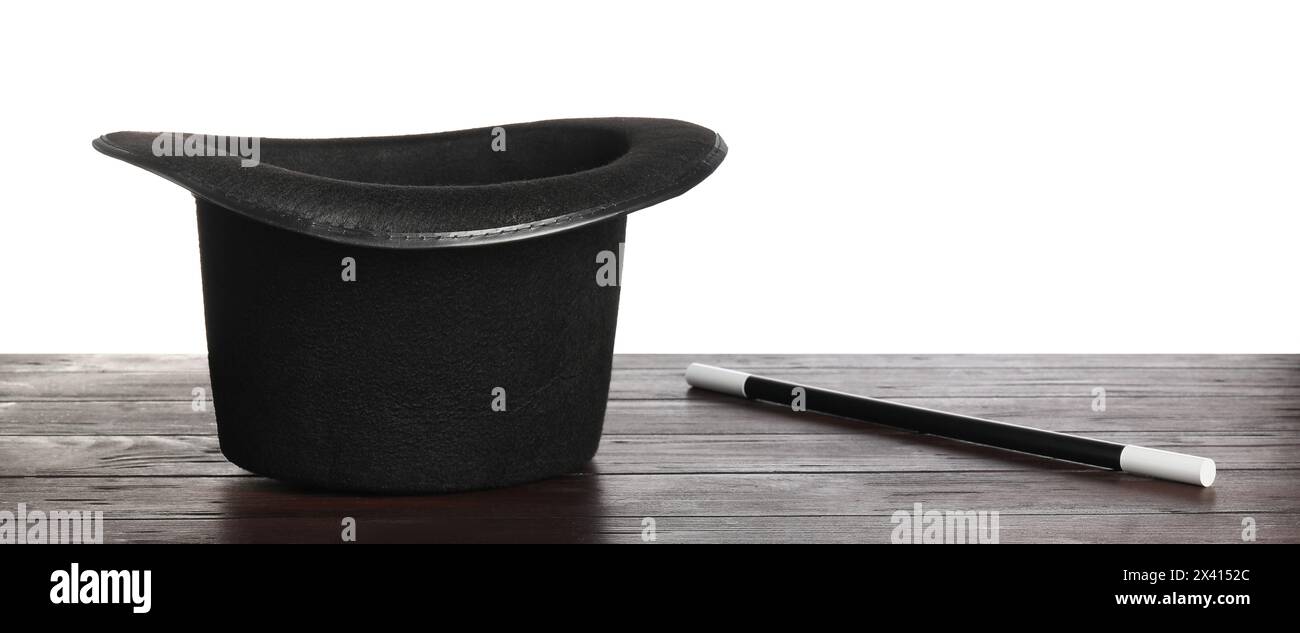 Magician's hat and wand on wooden table against white background Stock ...