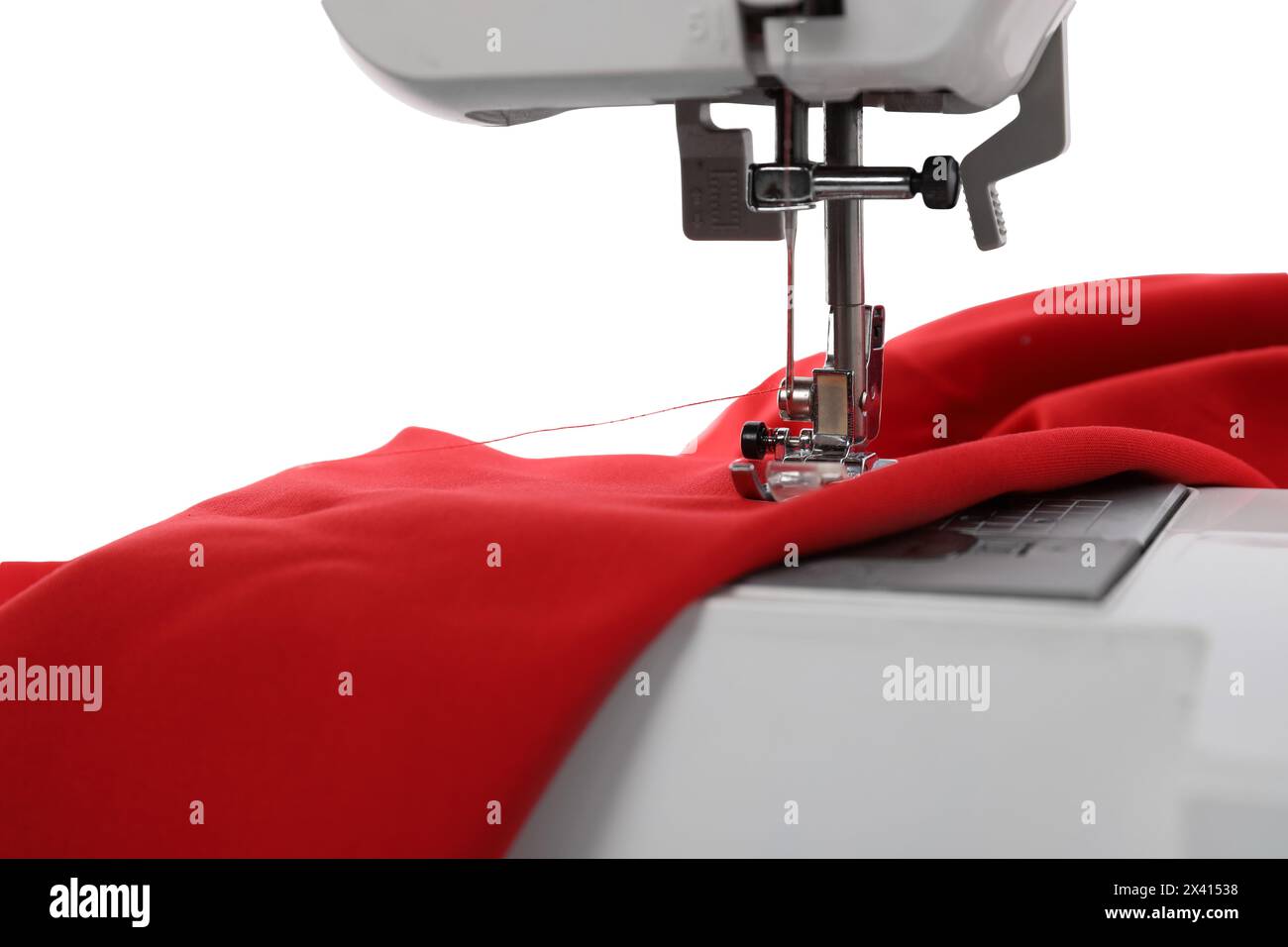 Sewing machine with red fabric isolated on white Stock Photo - Alamy