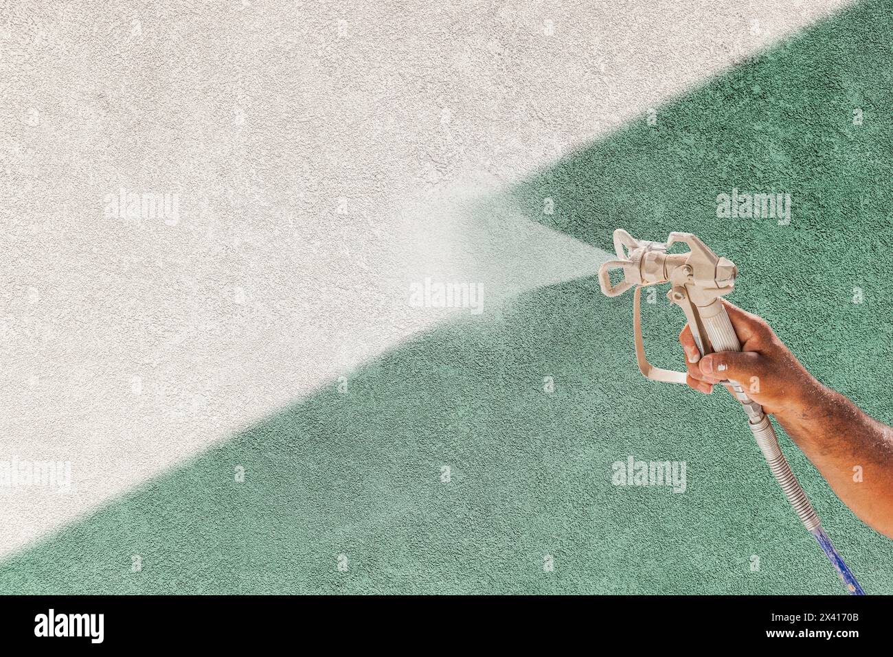 Professional Spray Painter Holding Spray Gun Spraying White Paint Over ...