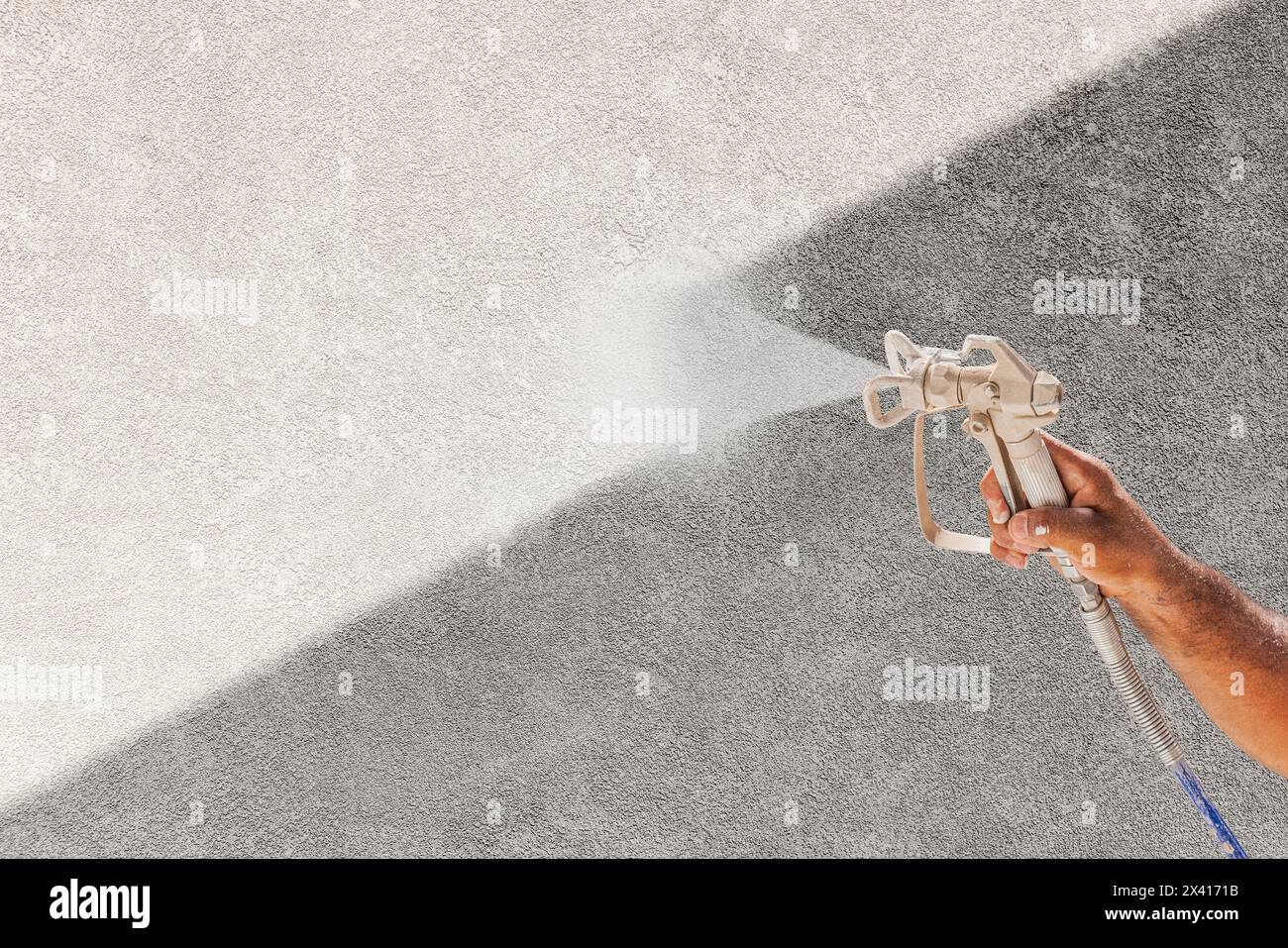 Professional Spray Painter Holding Spray Gun Spraying White Paint Over ...