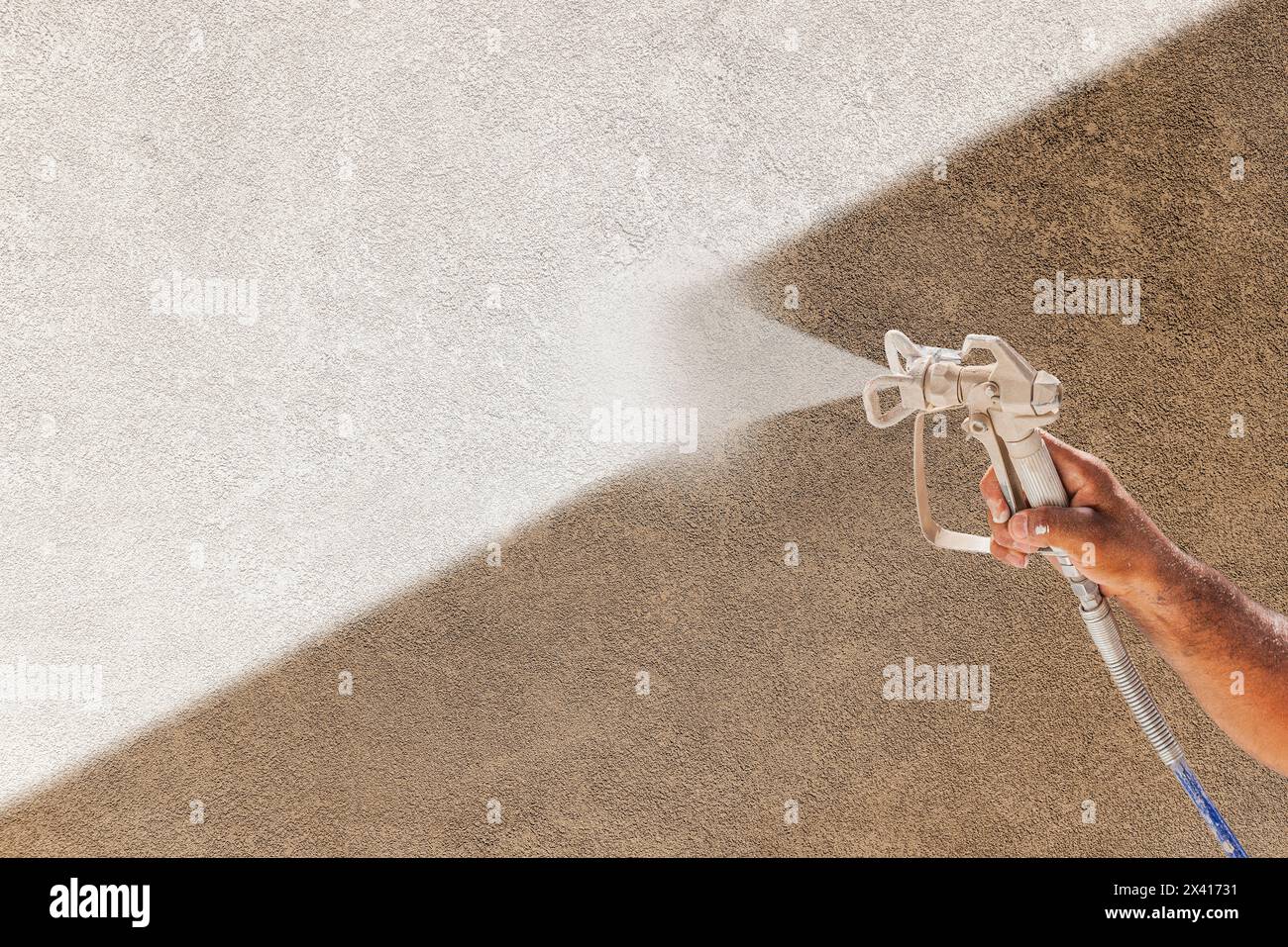 Professional Spray Painter Holding Spray Gun Spraying White Paint Over ...