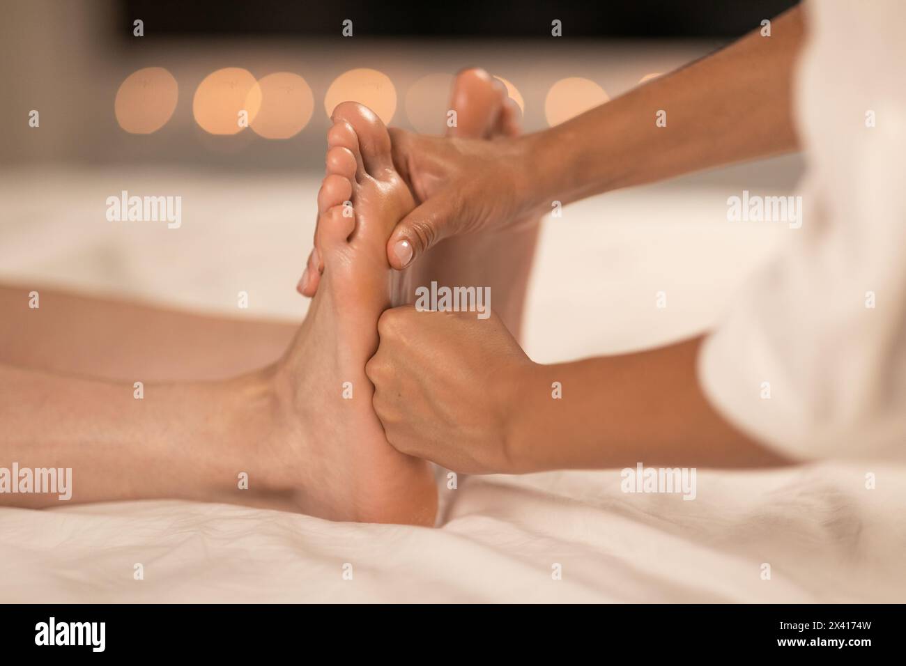 Woman Receiving Foot Massage in Bed, cropped Stock Photo - Alamy
