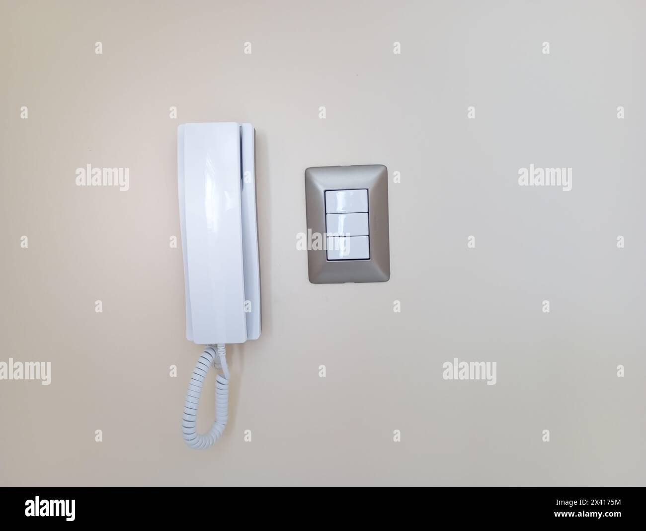 Simple intercom on white wall near the electric swithc Stock Photo - Alamy