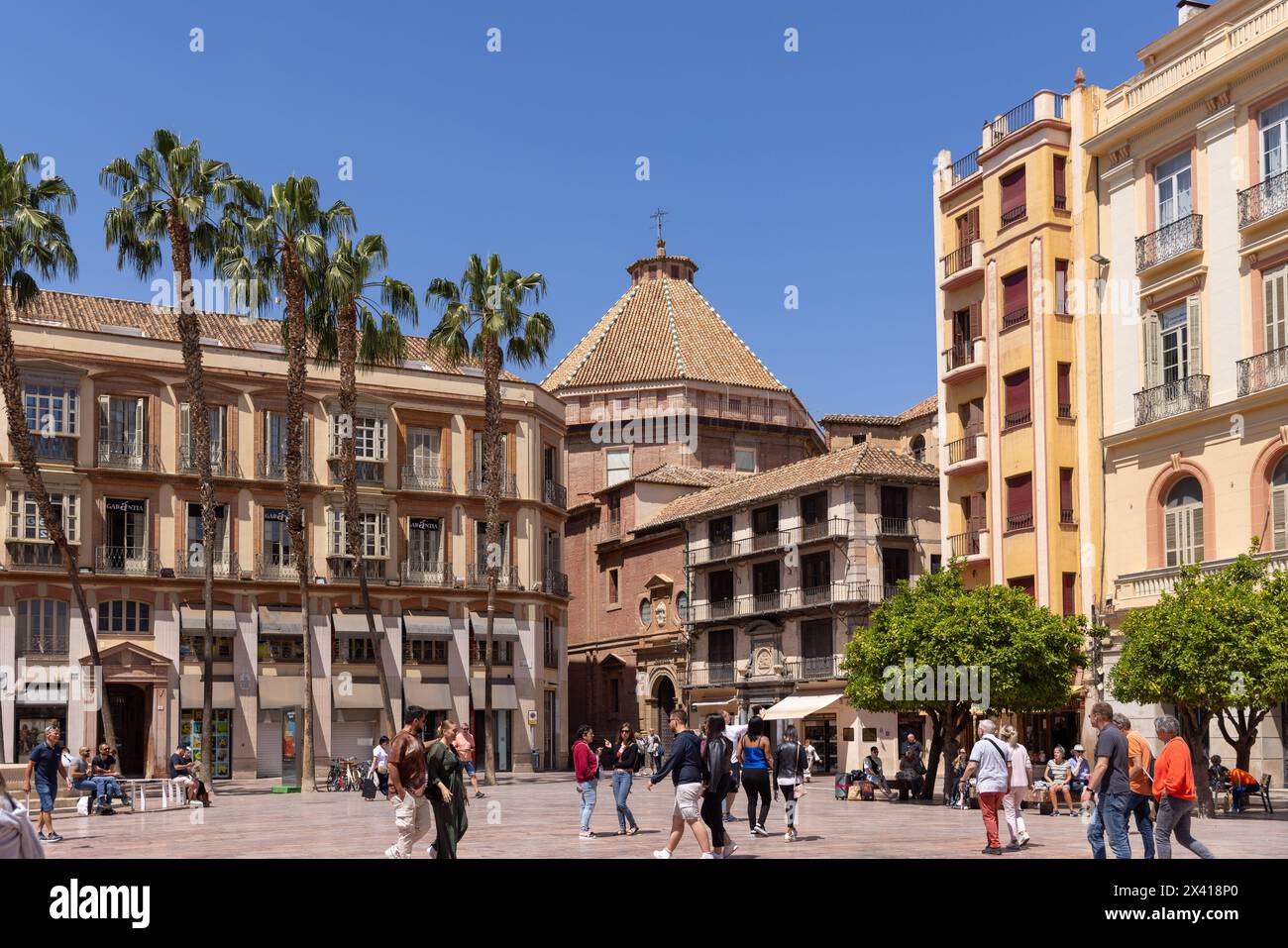 Historical building in Malaga old town with tourists walking the ...