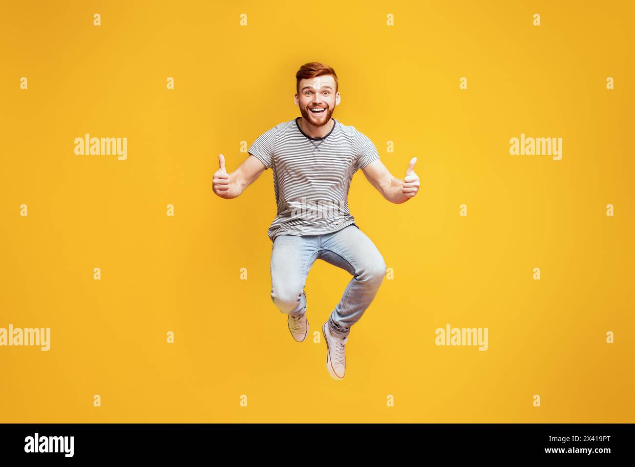 Happy joyful man jumping up in air, demonstrating thumbs up Stock Photo ...