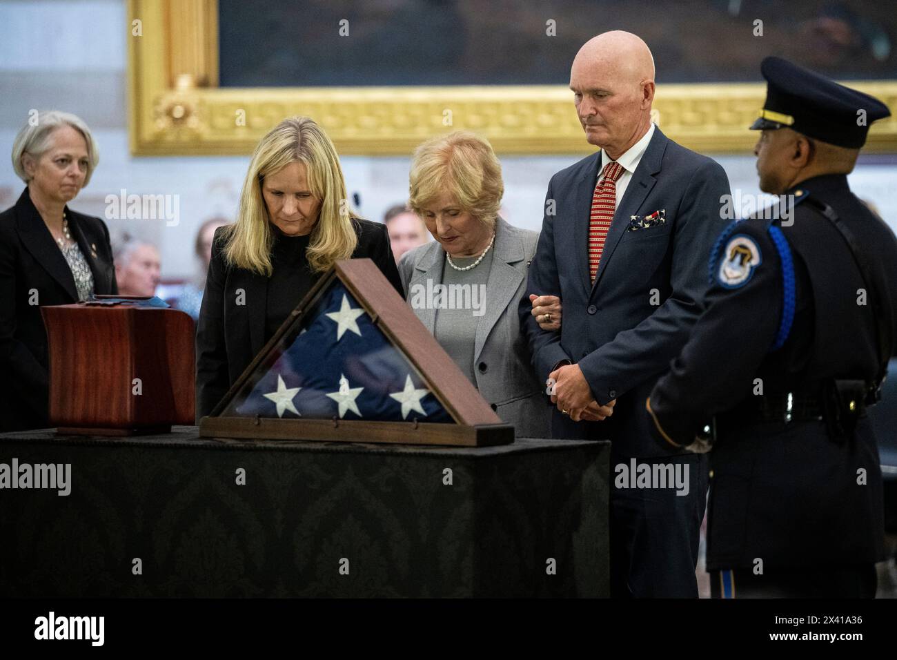 Family members of Col. Ralph Puckett Jr. pay respects during a ceremony for his remains to lie ...