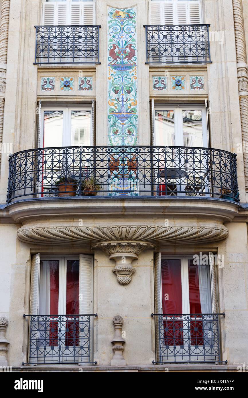 The facade of traditional French house with typical balconies and ...