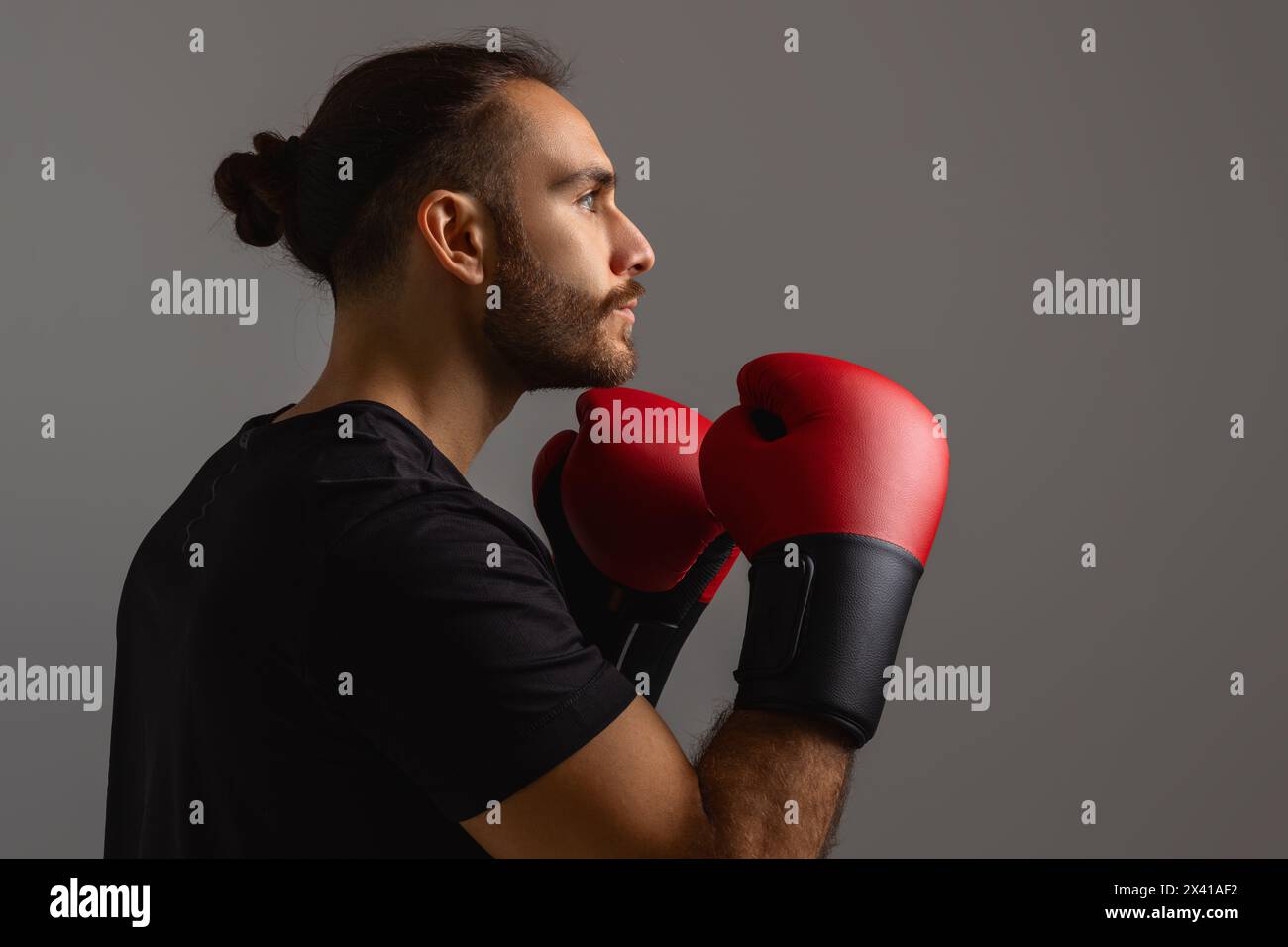 Man in Black Shirt and Red Boxing Gloves, Side View Stock Photo - Alamy